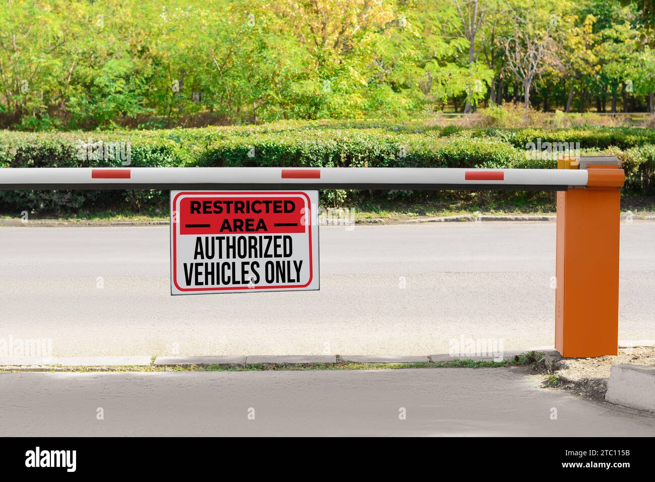 Sign with text Restricted Area Authorized Vehicles Only on boom barrier ...