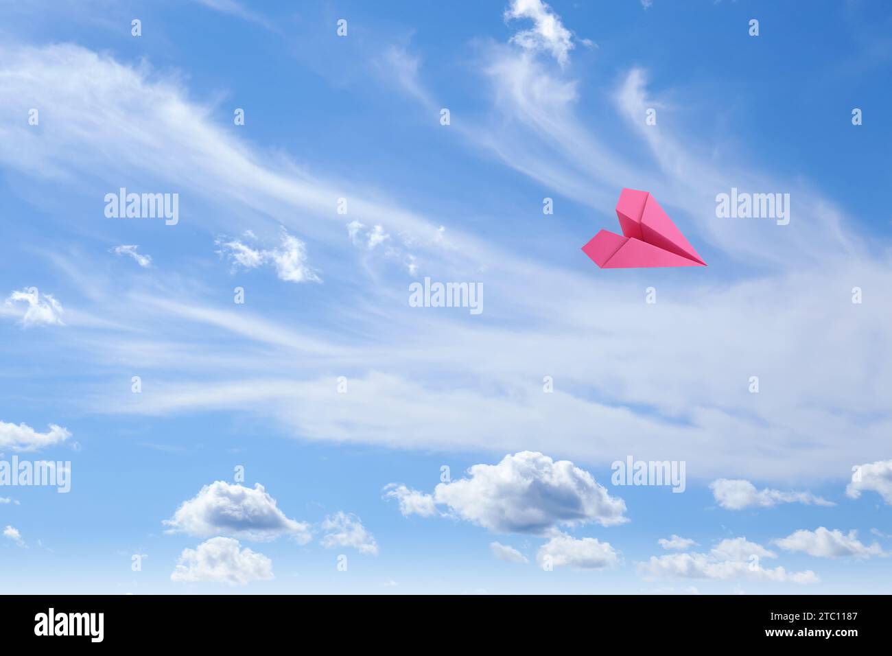 Pink paper plane flying in blue sky with clouds Stock Photo - Alamy