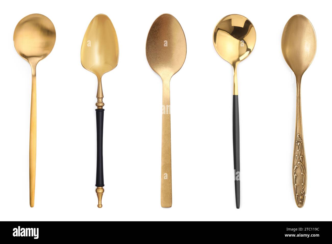 Different stylish golden spoons on white background Stock Photo - Alamy
