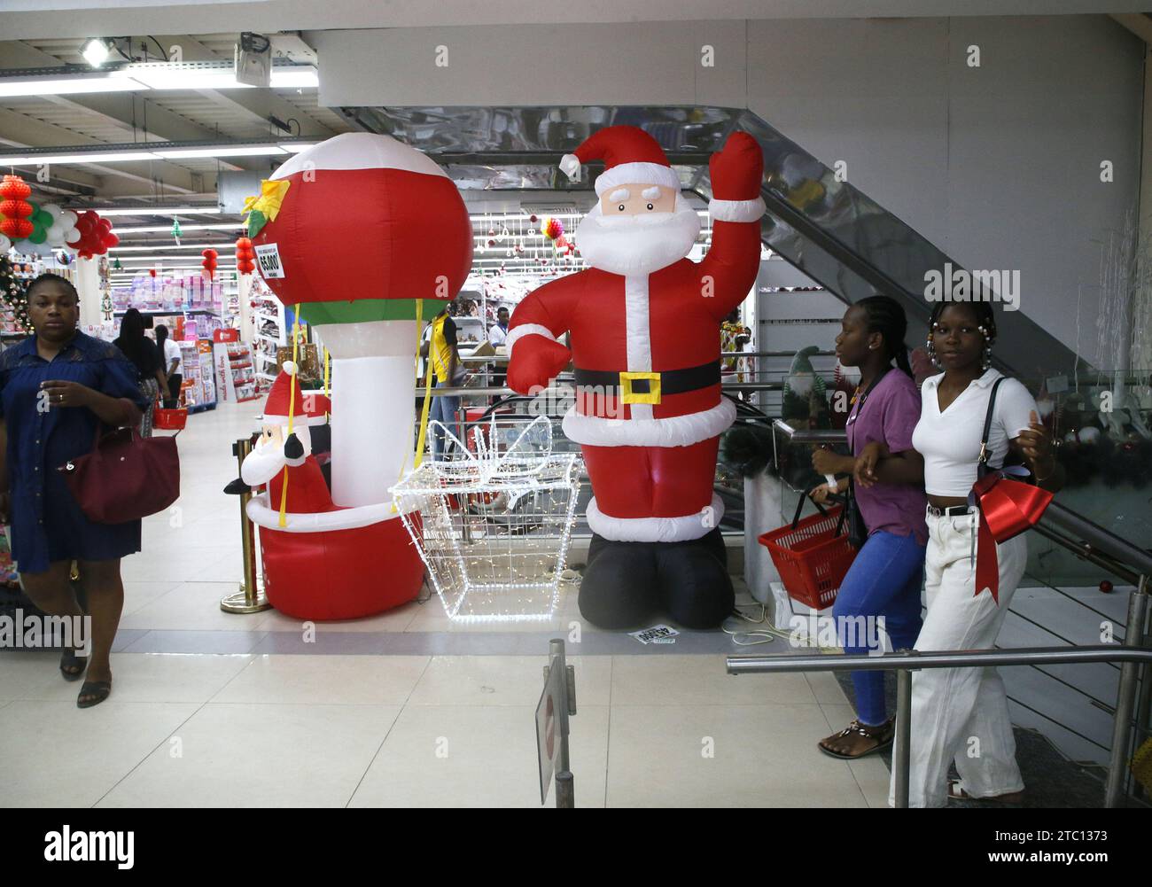 Abidjan, Cote d'Ivoire. 9th Dec, 2023. People walk past inflatable ...