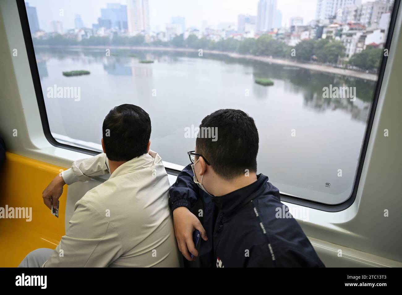Hanoi, Vietnam. 9th Dec, 2023. Passengers enjoy the view as they take a ...