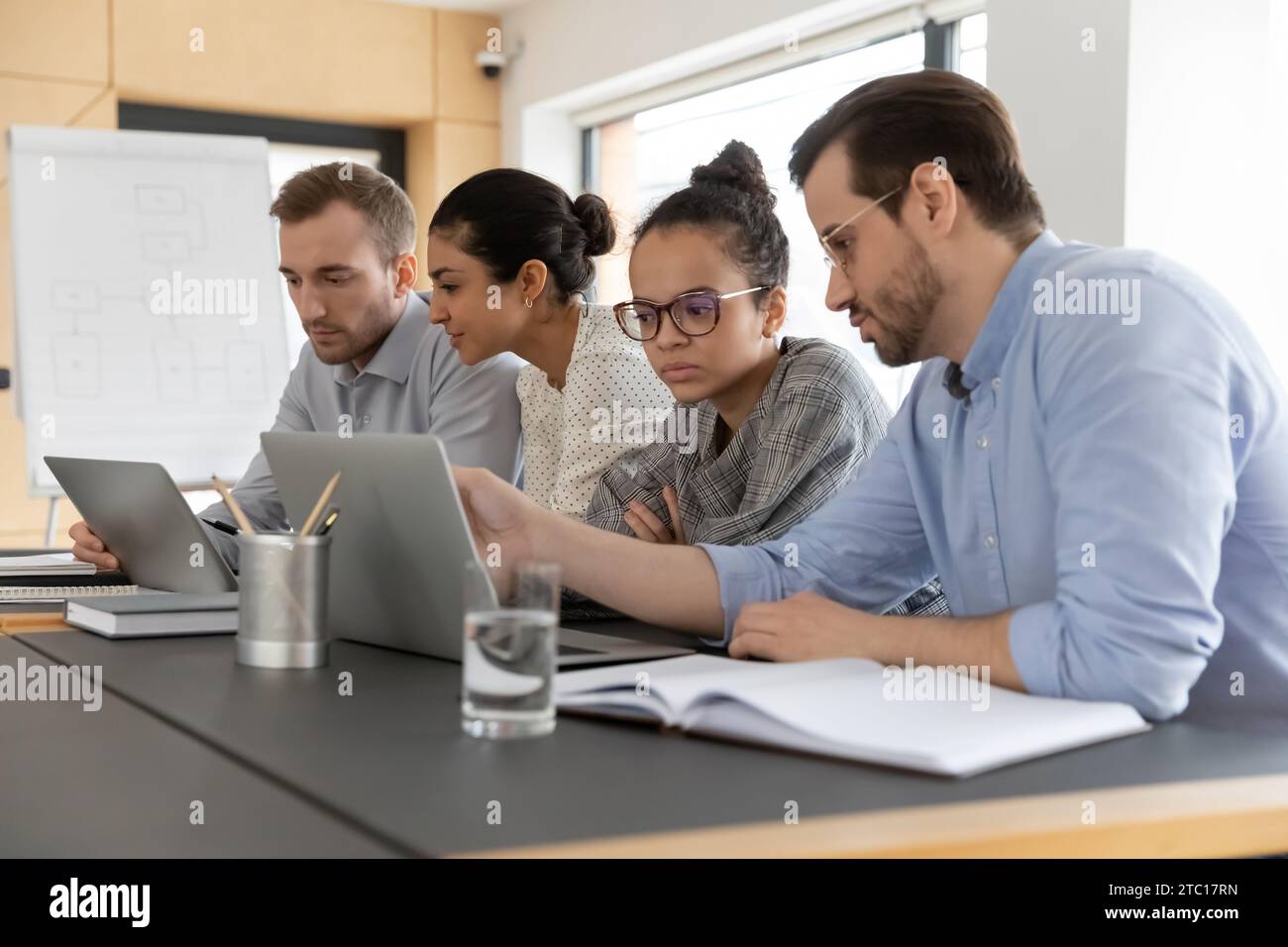 Multiracial business team using laptops hi-res stock photography and ...