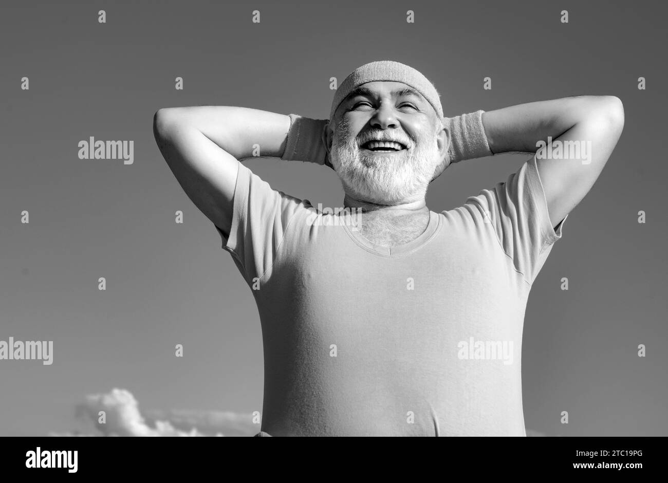 Freedom retirement concept. Elderly man practicing sports on blue sky ...