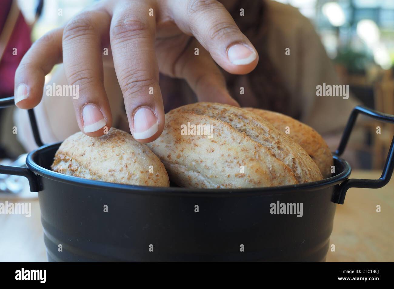 Women hand pick bread bun hi-res stock photography and images - Alamy
