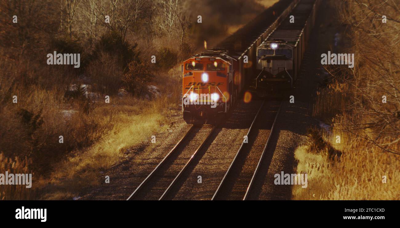 Freight train transporting coal, blasts the pastoral countryside and ...