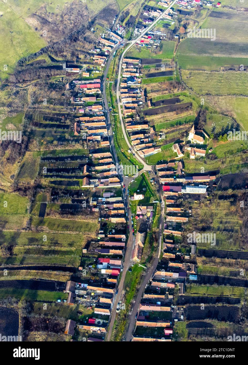 An aerial view of a picturesque village in Romania surrounded by lush ...