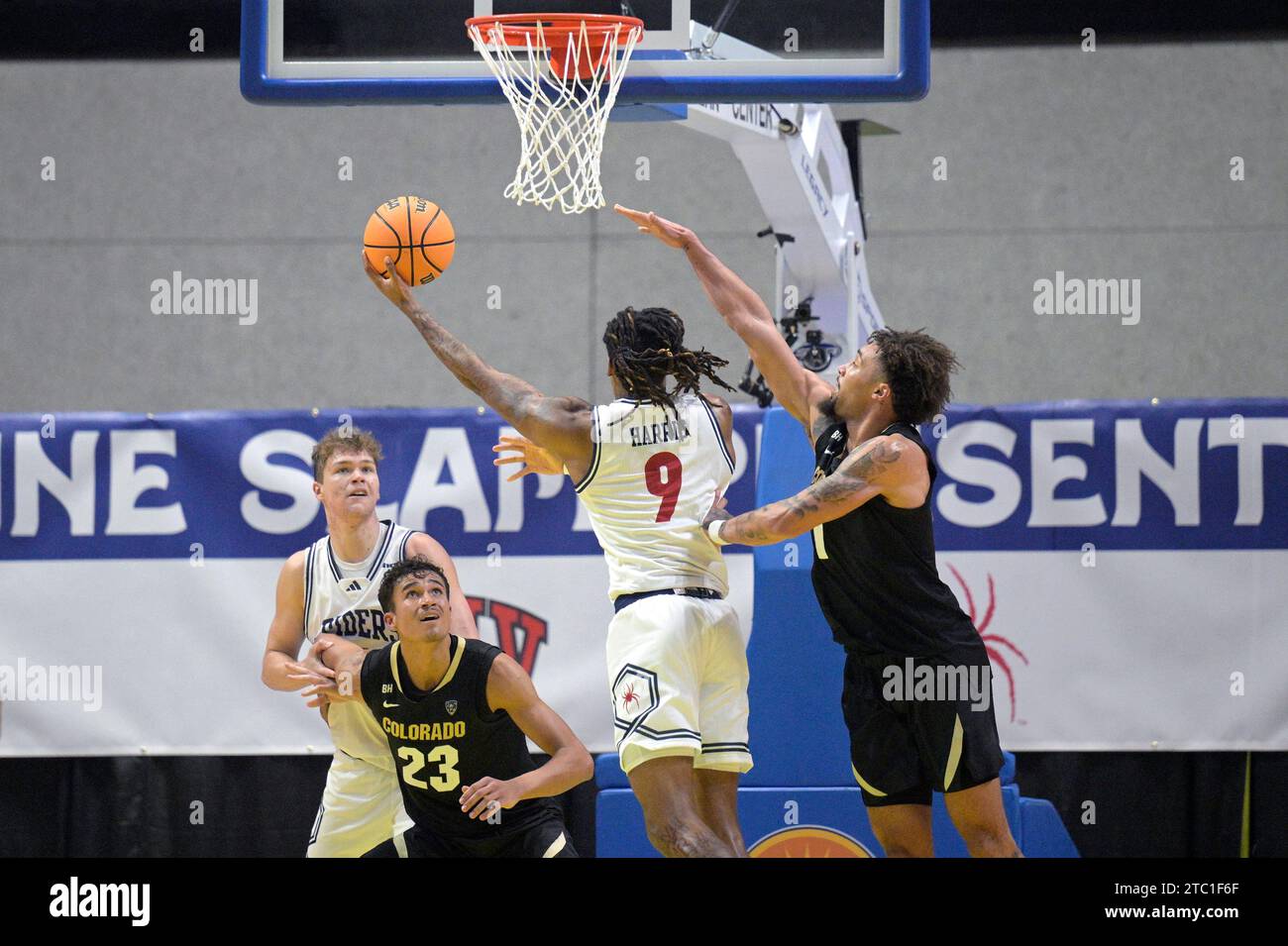 Richmond forward Tyler Harris (9) goes up for a shot between Colorado ...