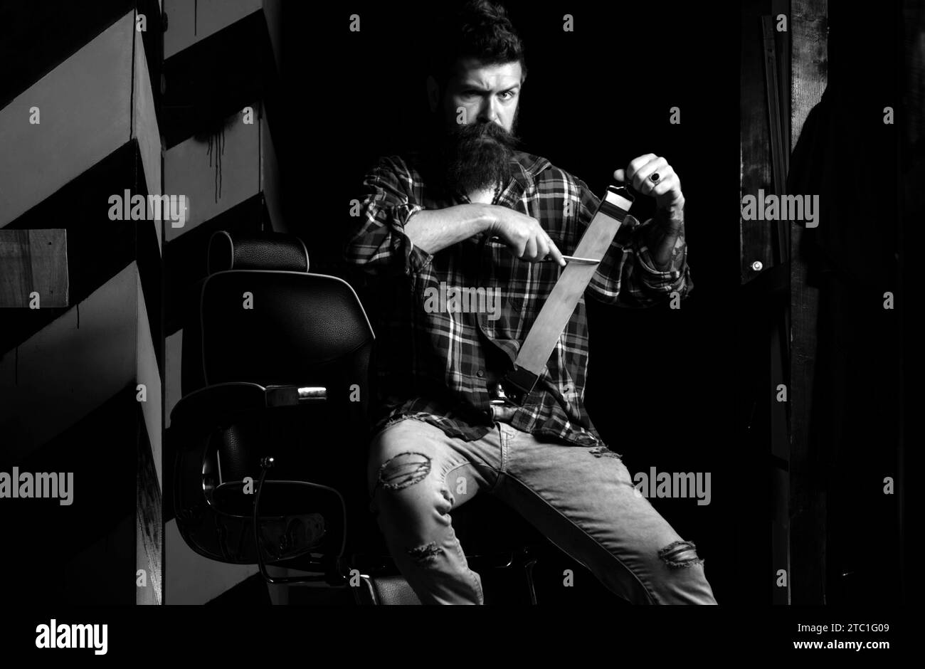 Professional hairstylist in barbershop interior. Male client getting ...