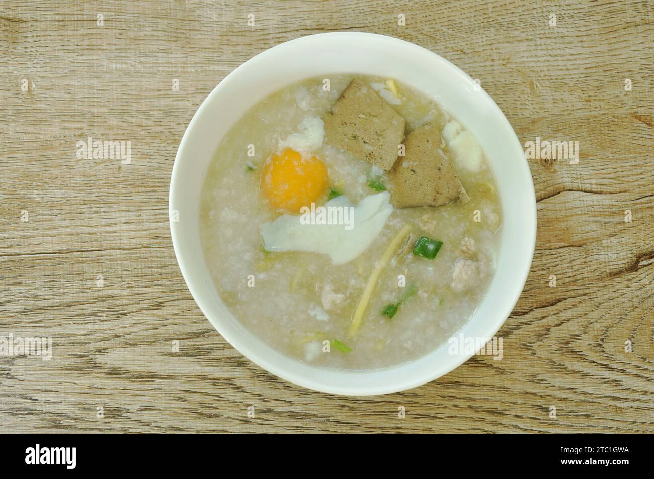 rice porridge mashed pork with chop spring onion and parsley topping ...