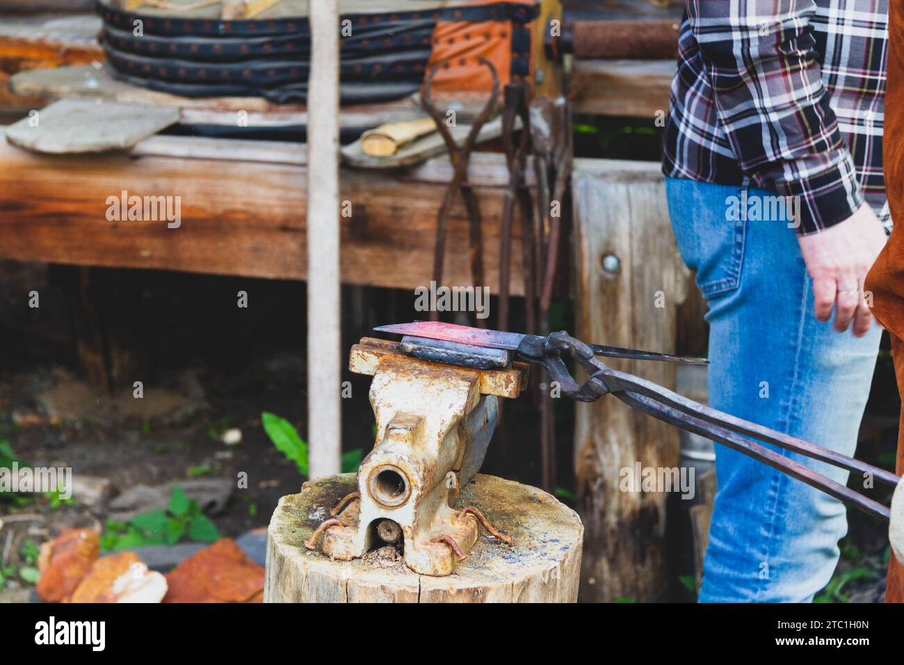 A blacksmith forges iron. Blacksmith's workshop. Blacksmith's anvil and ...