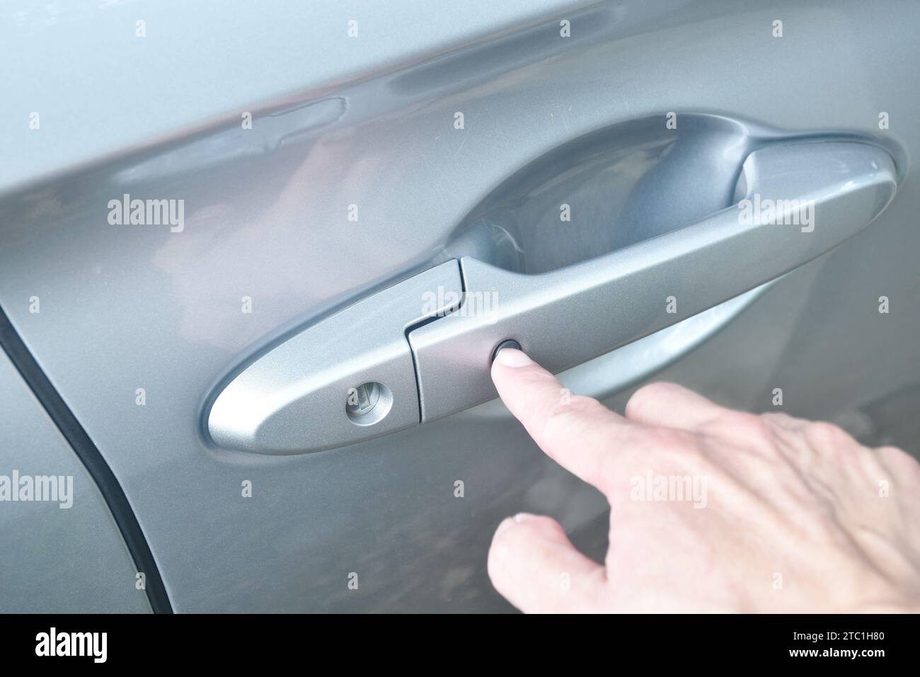 car door opened by finger pushing button and pulling Stock Photo - Alamy
