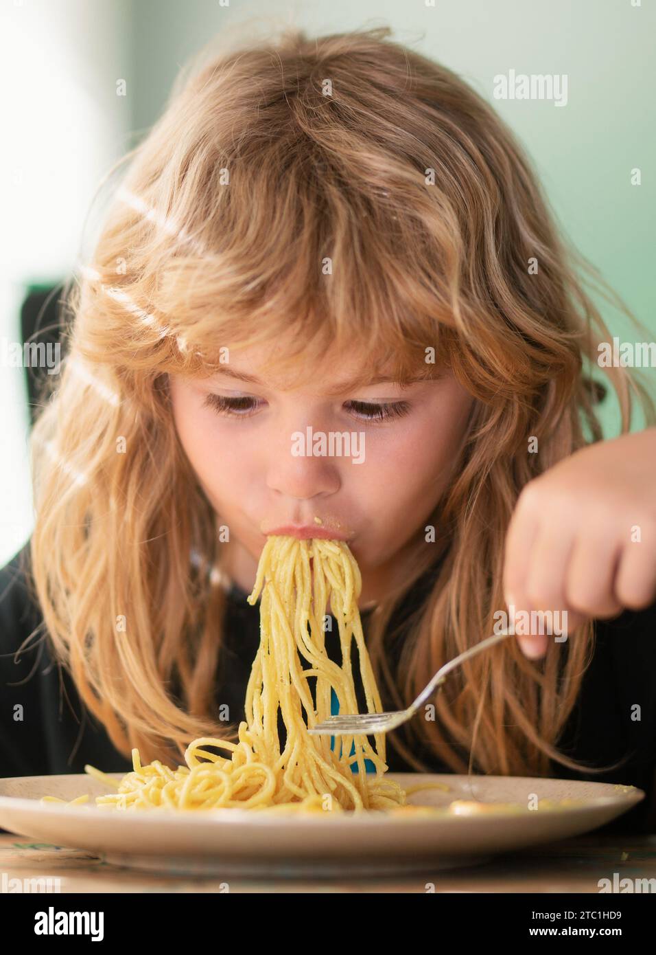 Tasty food, messy child eating spaghetti. Child have a breakfast. Tasty ...
