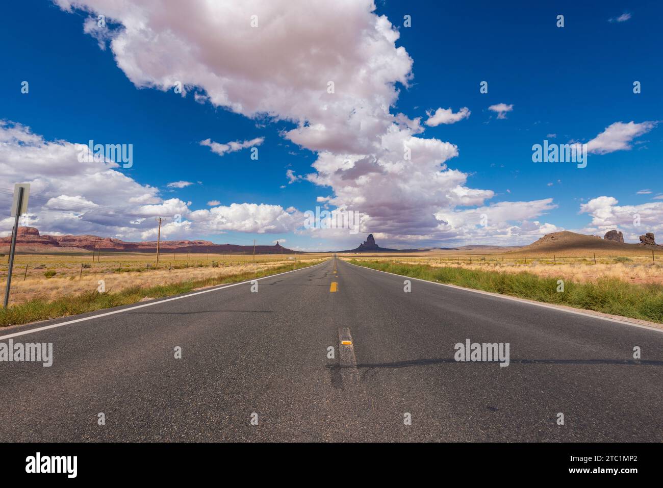 Yellow lines of the highway and blue skies with white clouds on the way ...