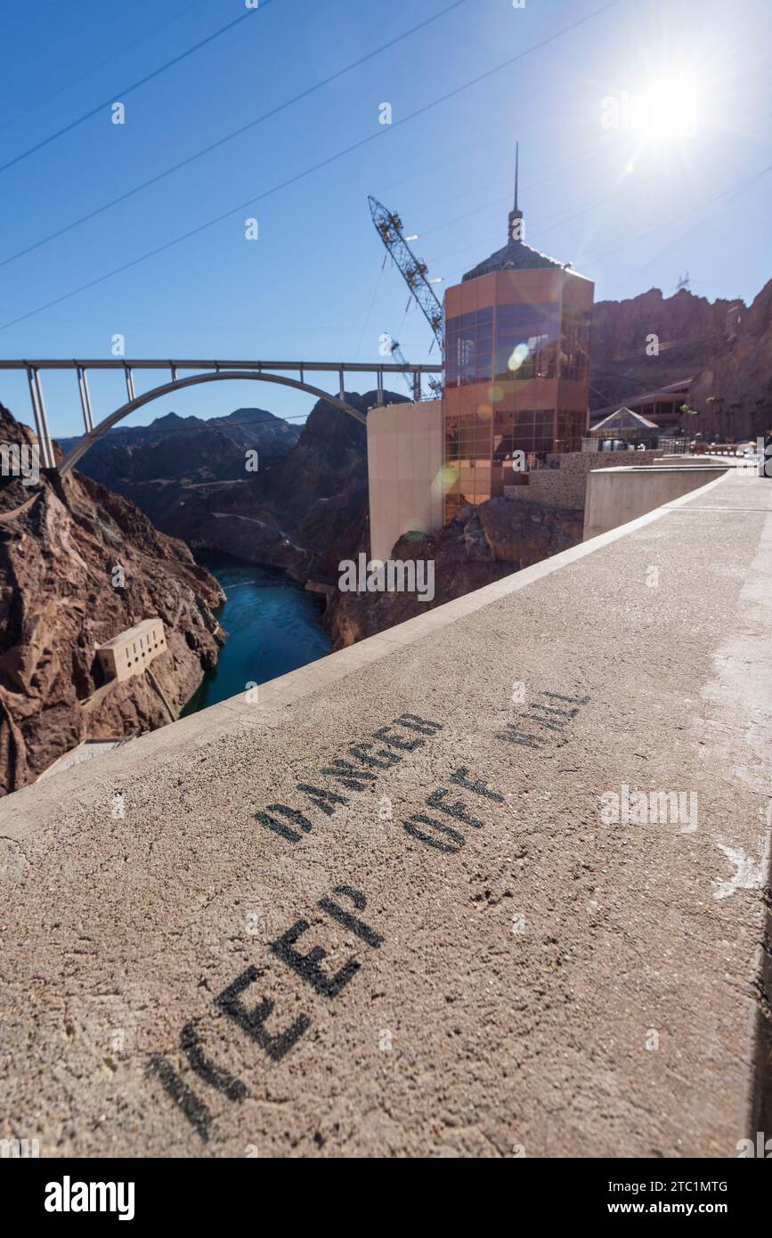 A danger keep off sign is painted on the top of the wall of the Hoover ...