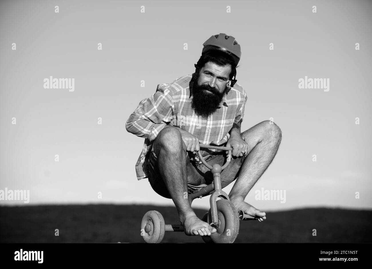 Crazy Young man riding three wheeled bicycle Stock Photo - Alamy