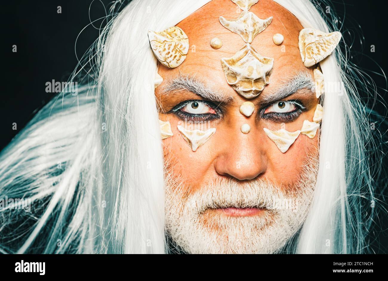 Elderly man holding two red horns. Burning diabolic demon summons evil ...