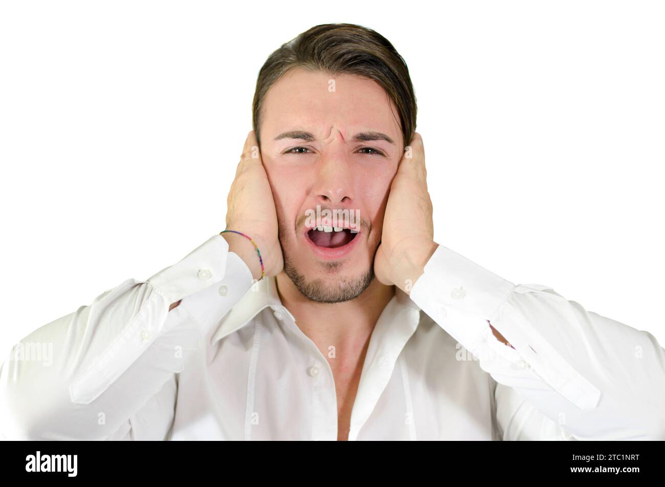 Too much noise, attractive young man covering his ears, isolated on ...
