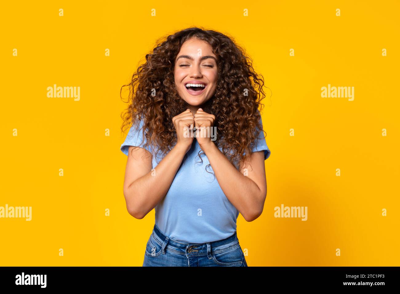 Excited woman in yellow hi-res stock photography and images - Alamy