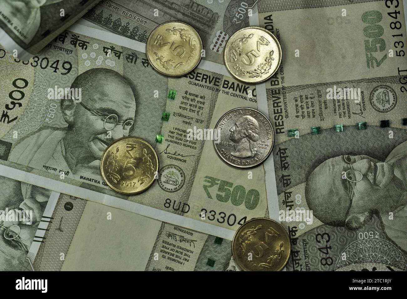 US Quarter dollar is stacked under Indian currency of five hundred ...