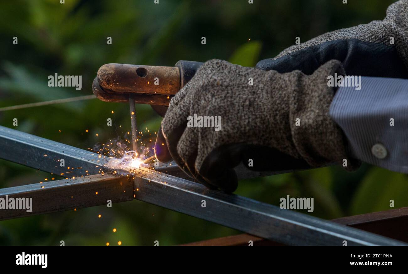 Shielded metal arc welding a steel frame with proper protection Stock ...