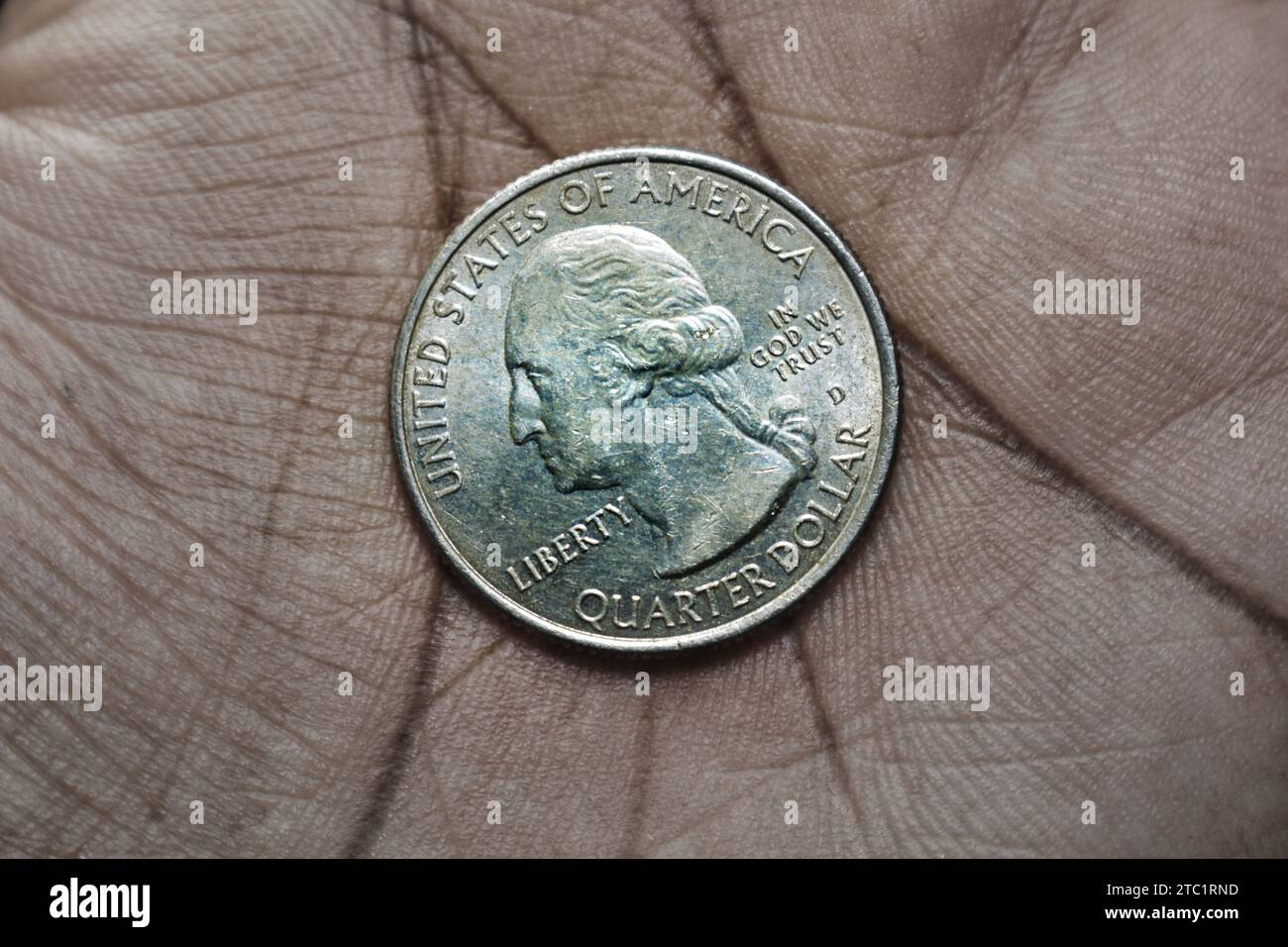 US Quarter dollar against plam background Stock Photo - Alamy