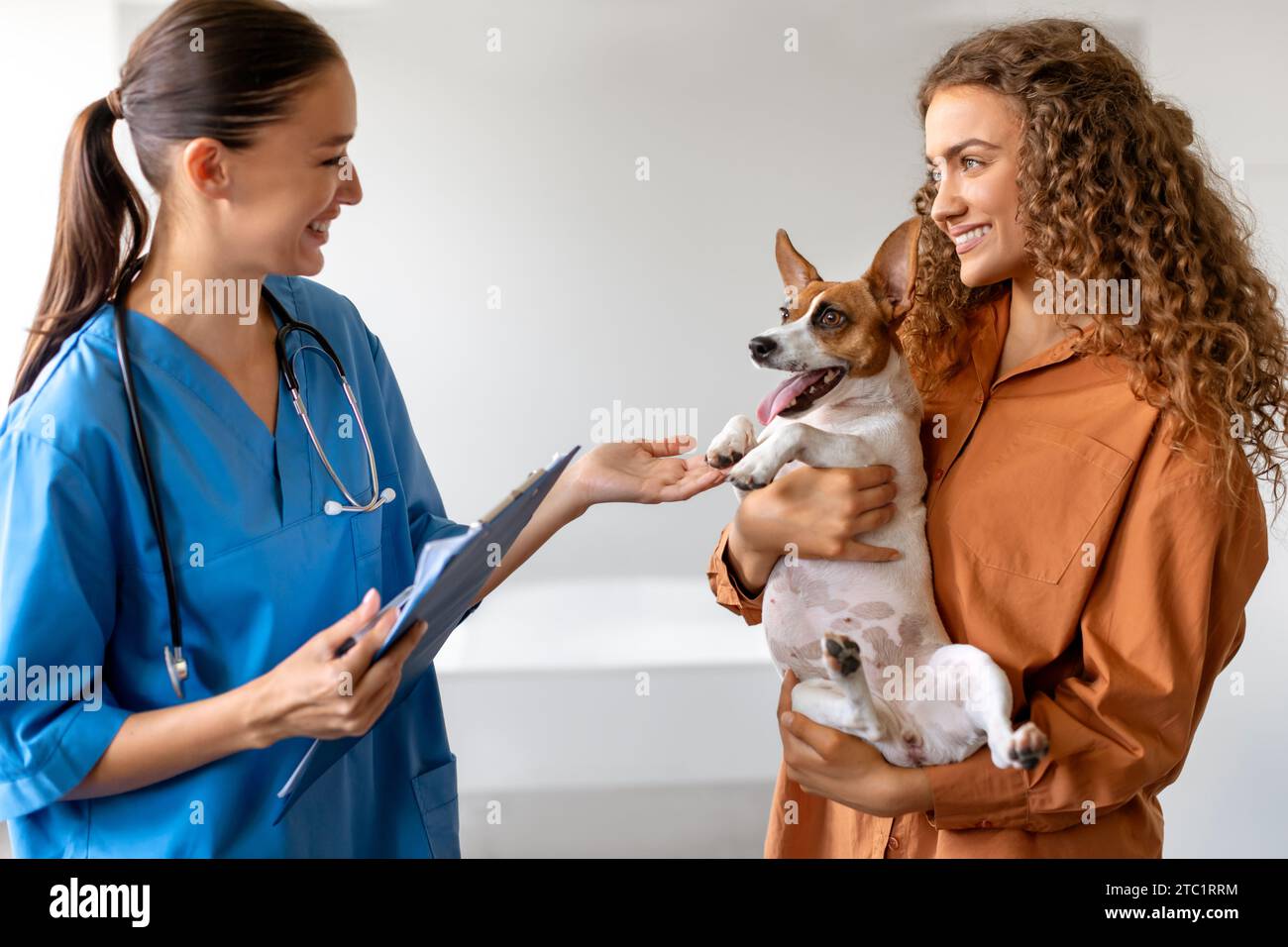Vet clinic visit with dog and women Stock Photo - Alamy