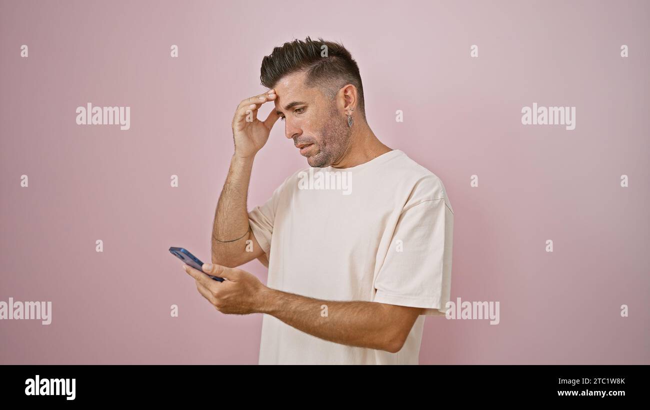Worried young hispanic man, cool yet stressed, standing isolated over ...