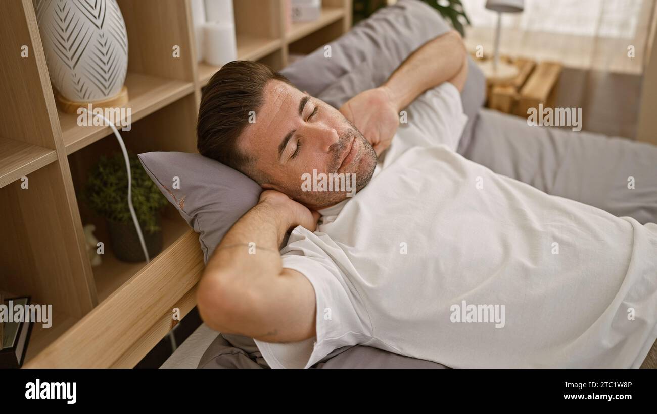Exhausted young hispanic man, a portrait of worry, lying in his bed ...