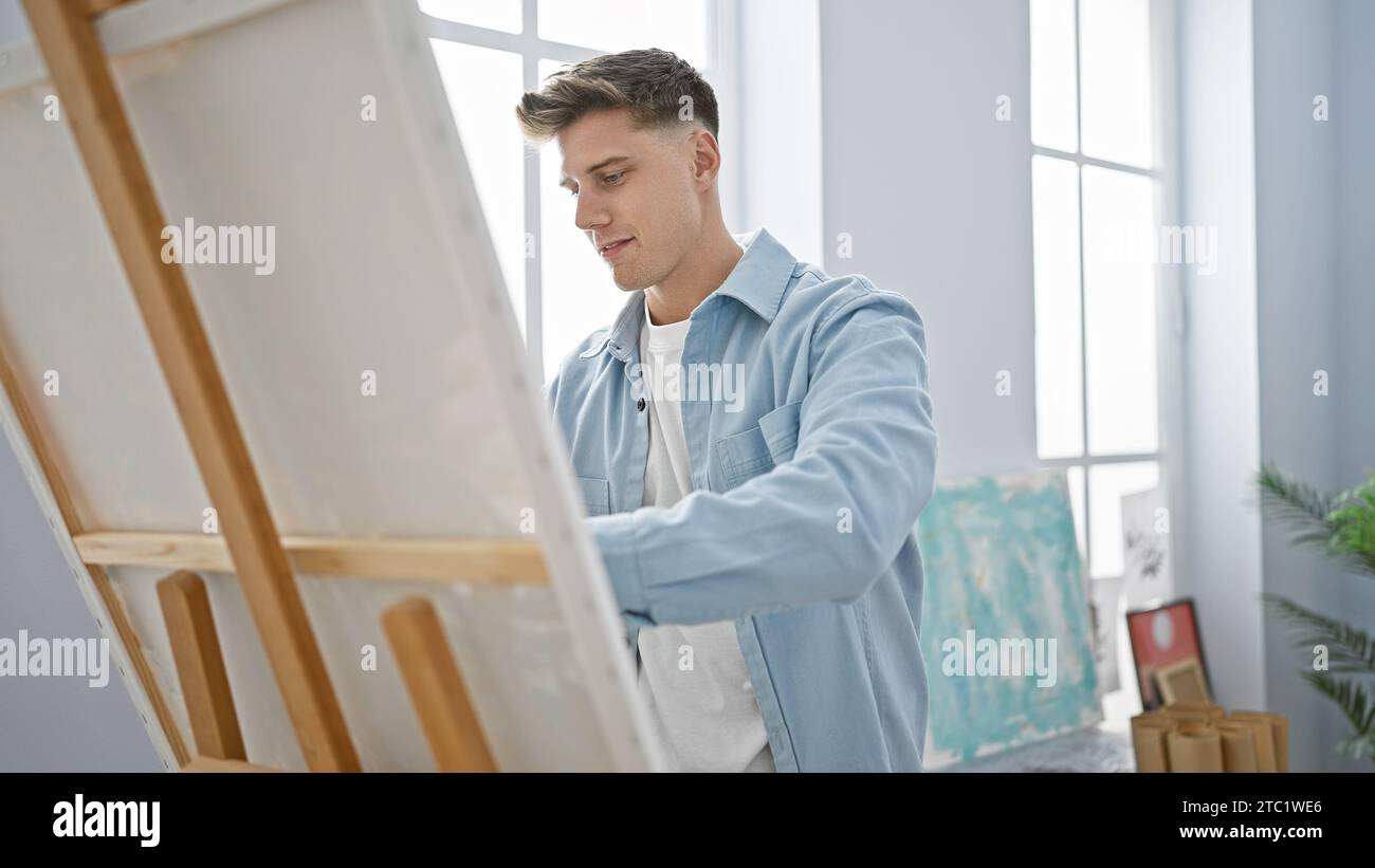Handsome young caucasian man, deeply focused, drawing passionately in ...