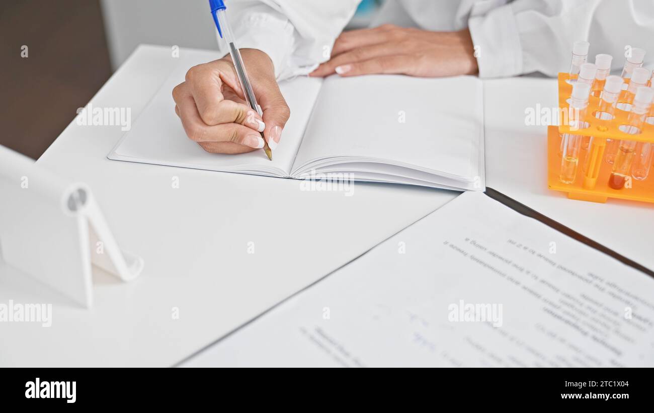 Hands of woman scientist taking notes at laboratory Stock Photo - Alamy