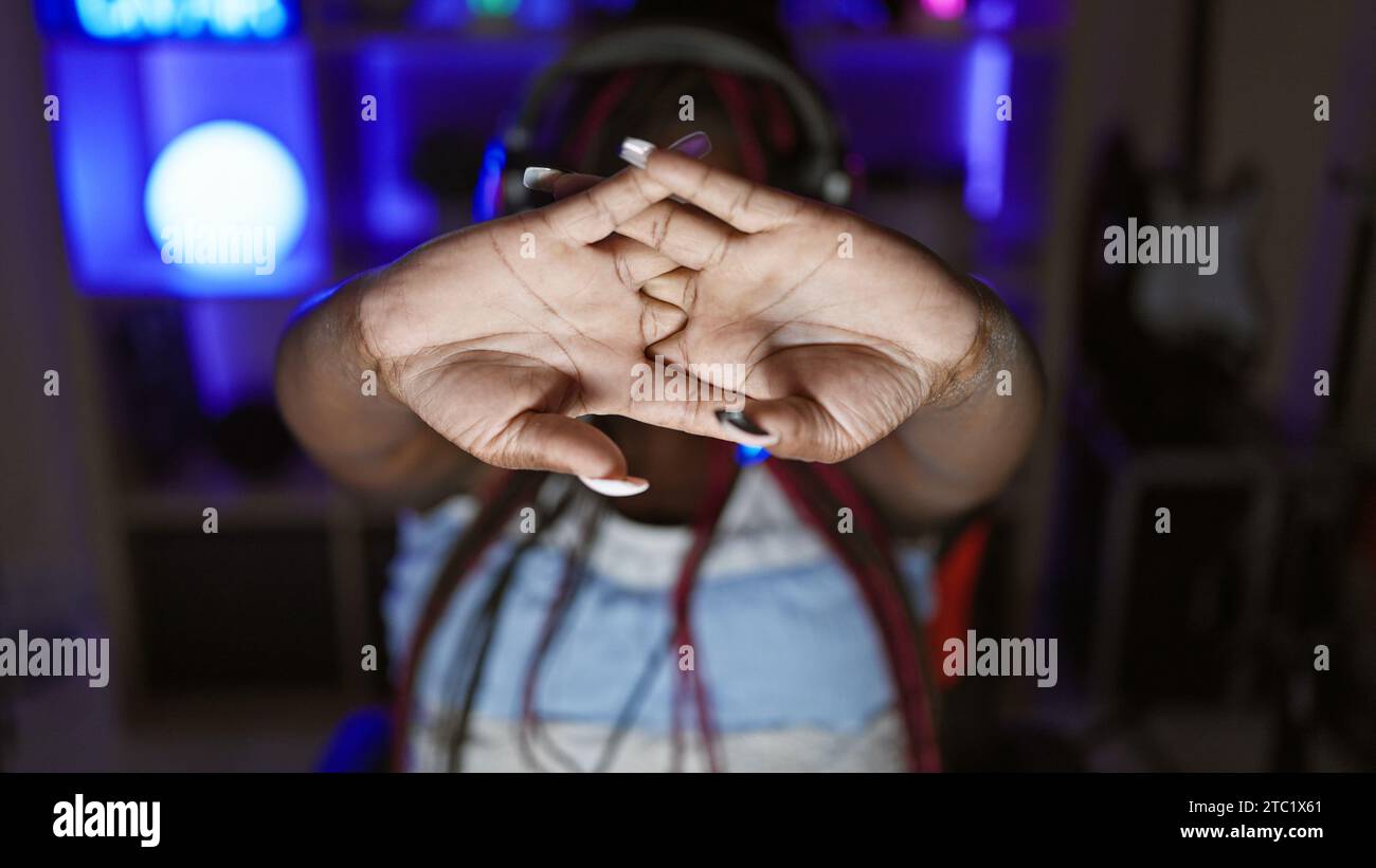 Night streaming, stunning african american woman streamer stretching ...