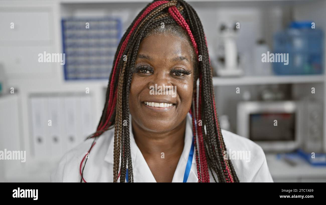 Confident african american woman scientist with braids, smiling ...