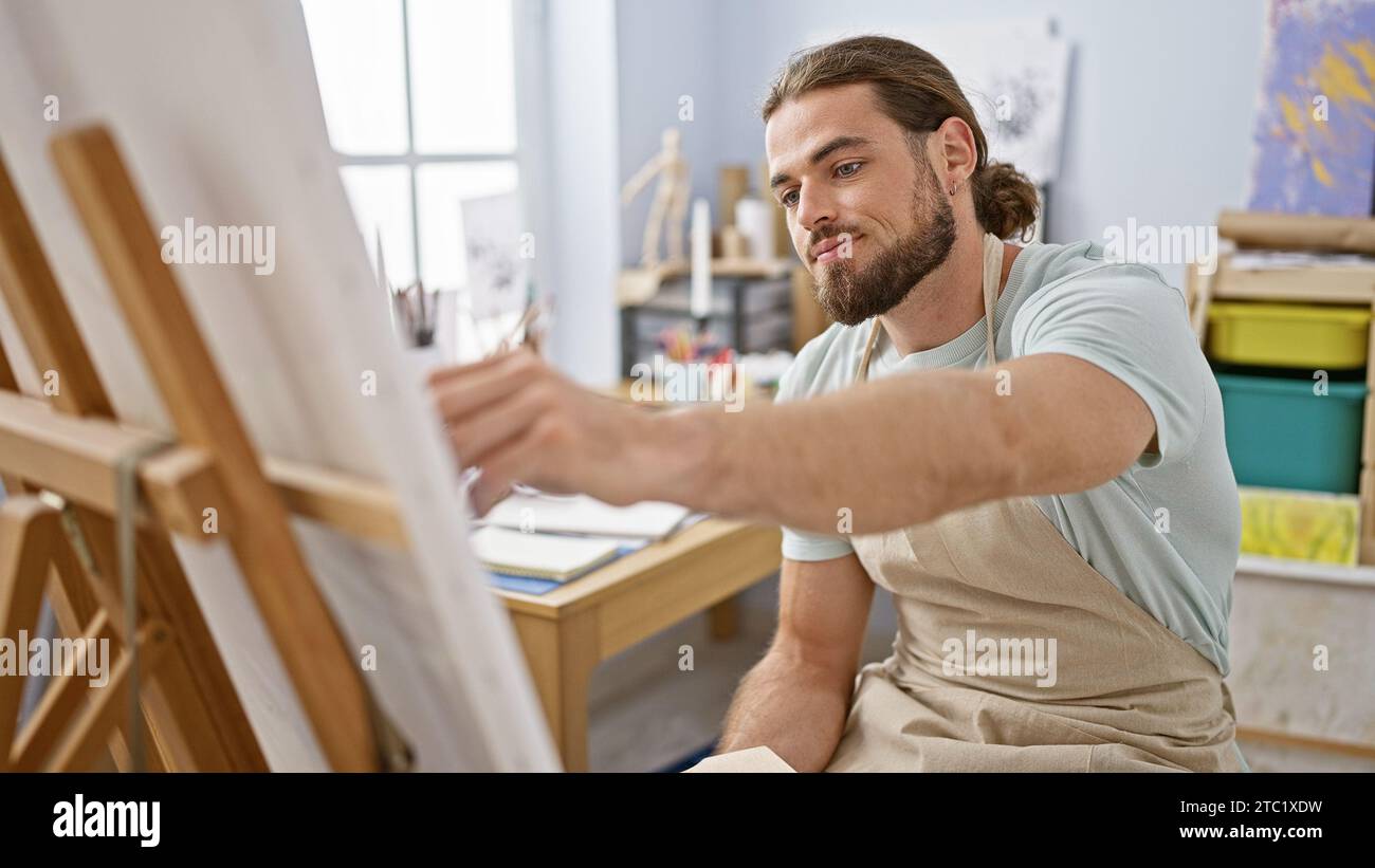 Young hispanic man artist drawing at art studio Stock Photo - Alamy
