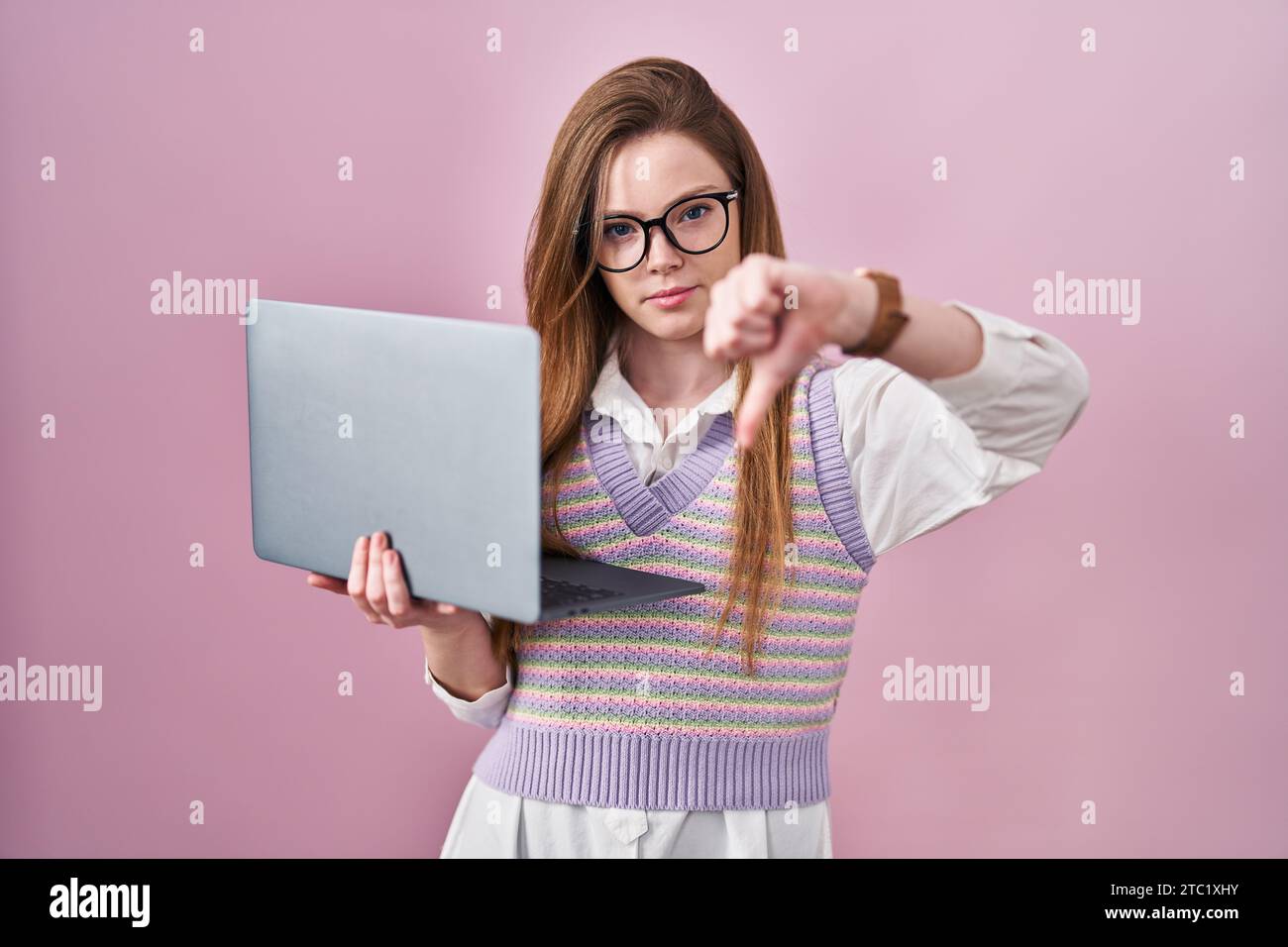 Young caucasian woman working using computer laptop looking unhappy and ...