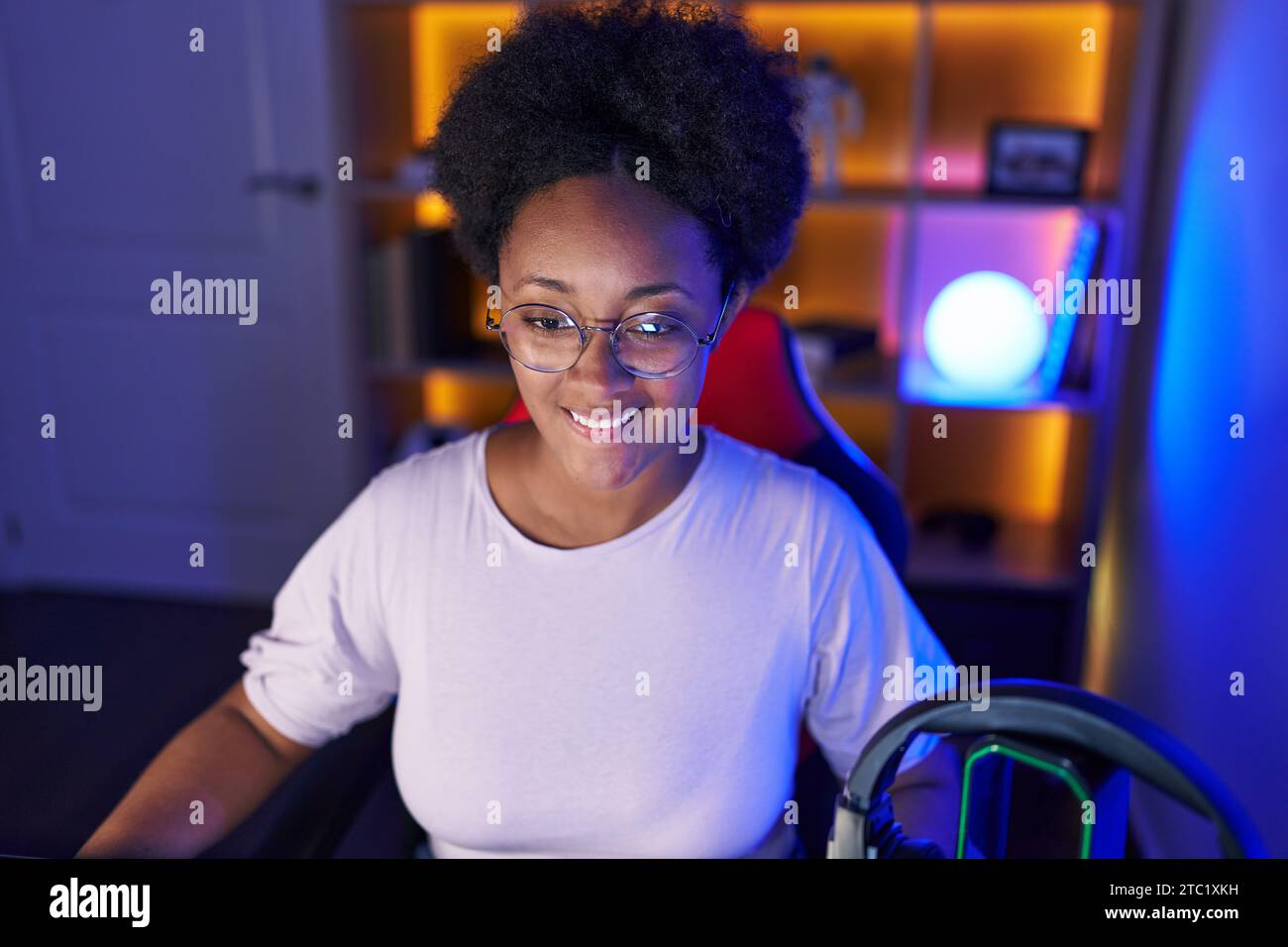 African american woman streamer playing video game using computer at ...