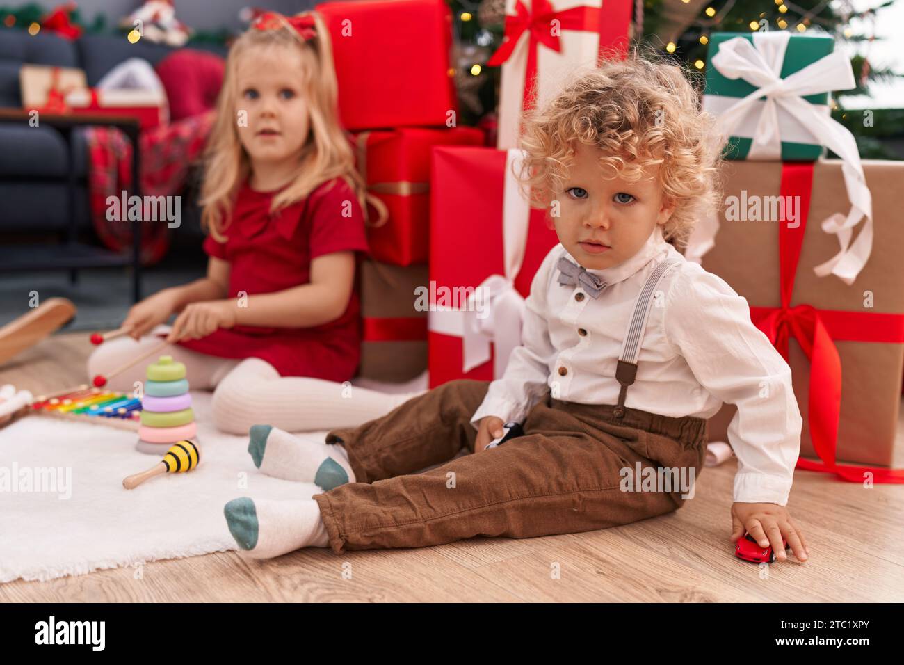 Adorable boy and girl playing with xylophone and car toy celebrating ...