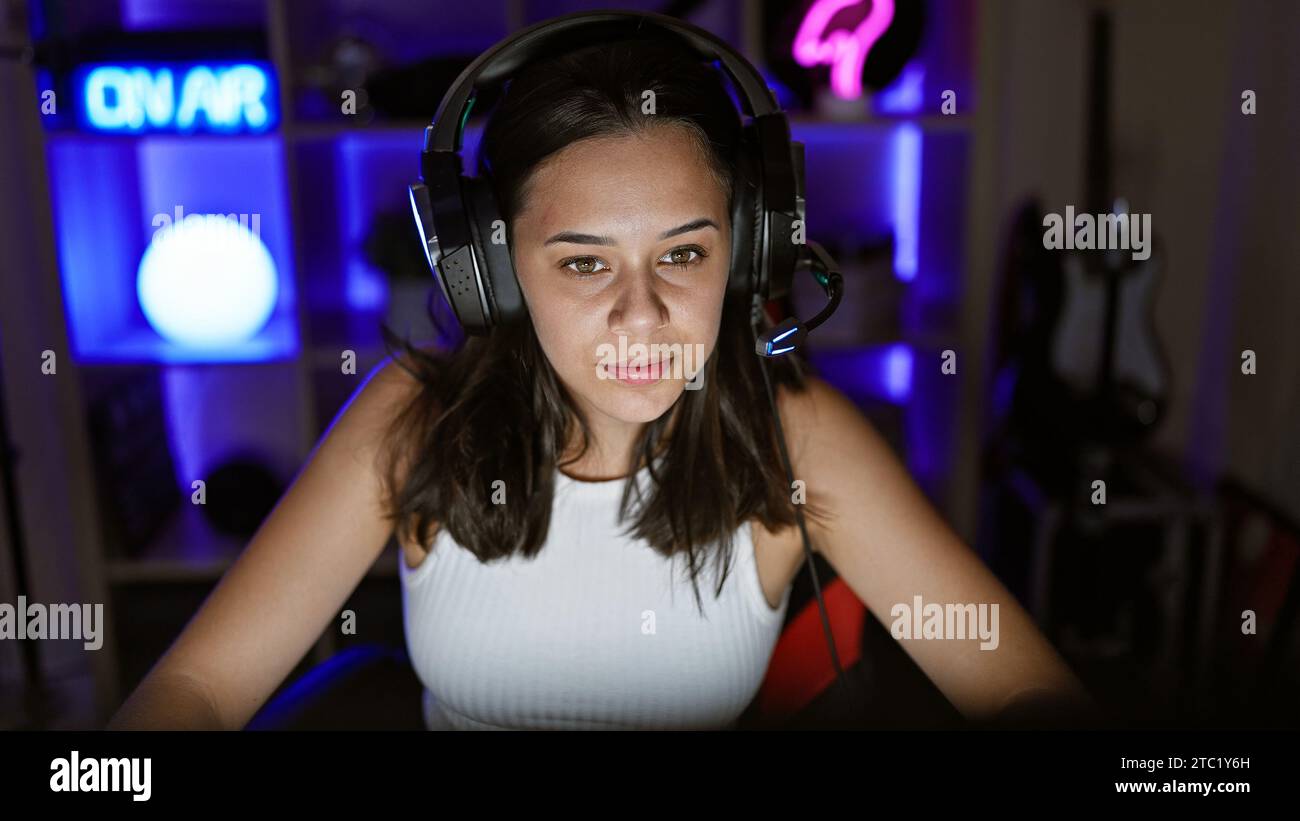 Young beautiful hispanic woman streamer playing video game using ...