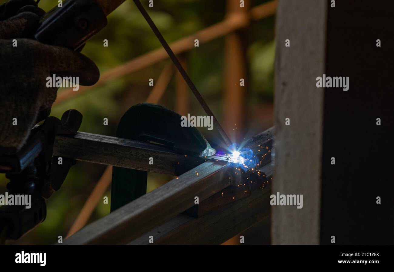 Arc welding process with G clamp to keep the metal bars together while ...