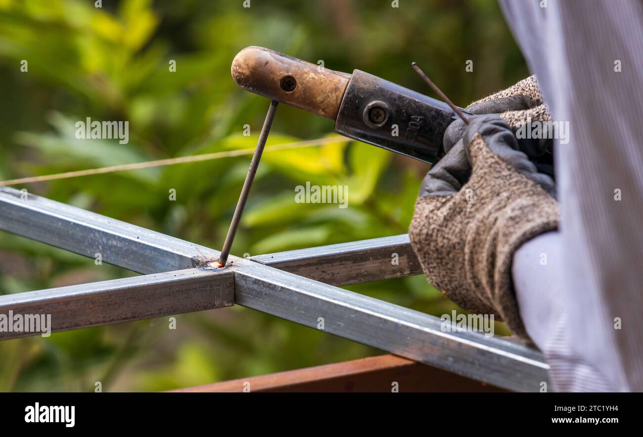 Initiating the SMAW welding process by welder, square tubes joining ...