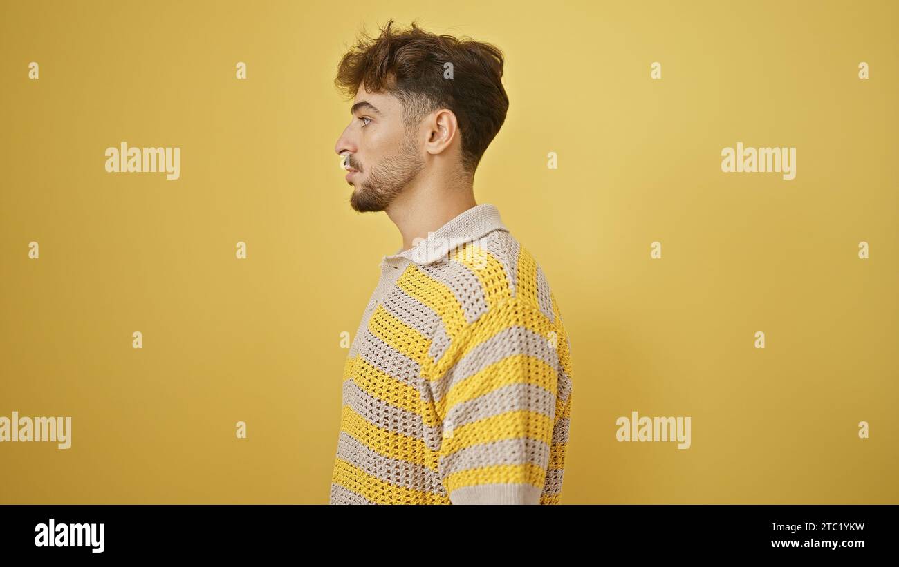 Arab man in his relaxed yet serious stance, looking off to the side ...