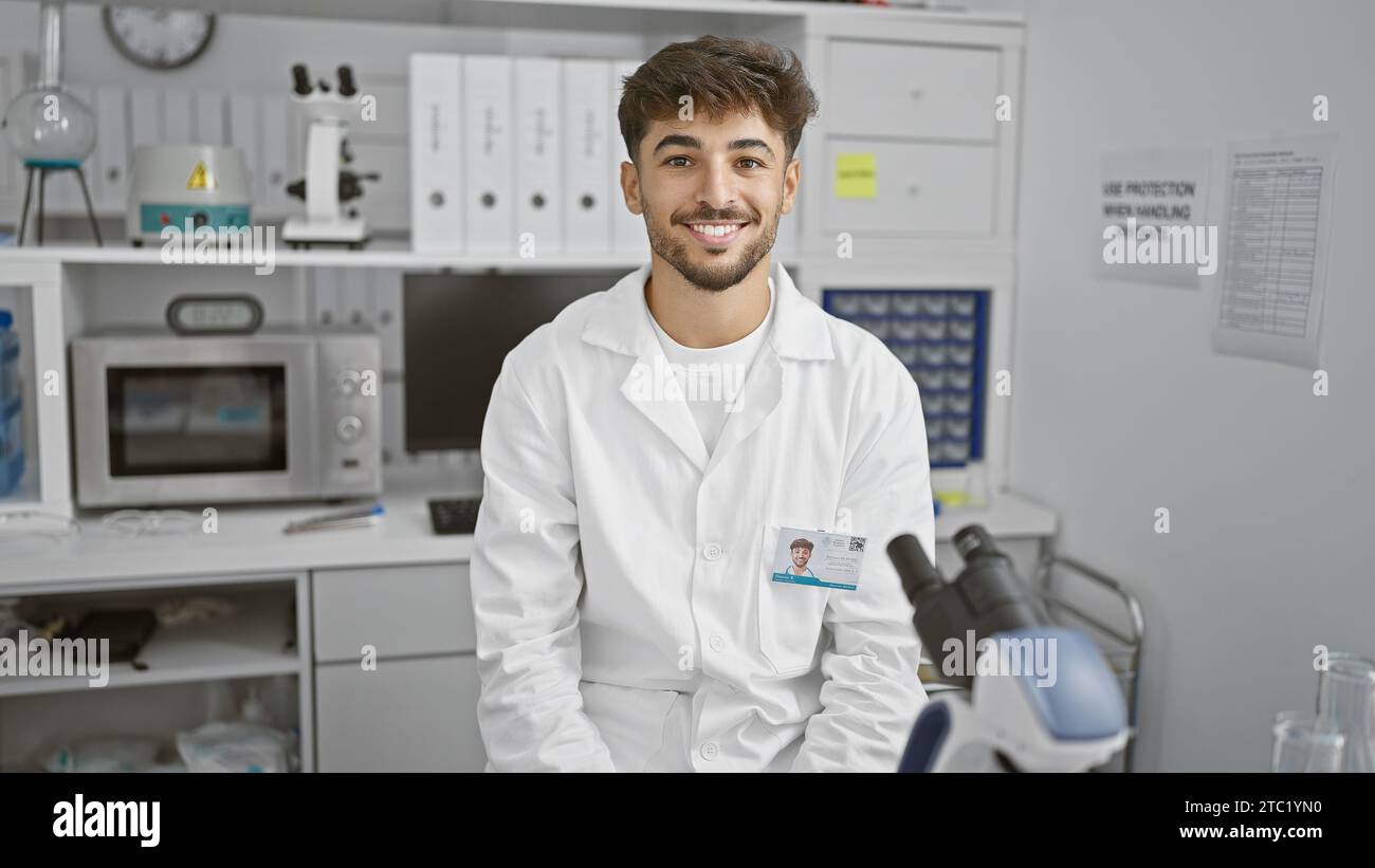 Confident young arab man, a smiling scientist, dives into research in ...