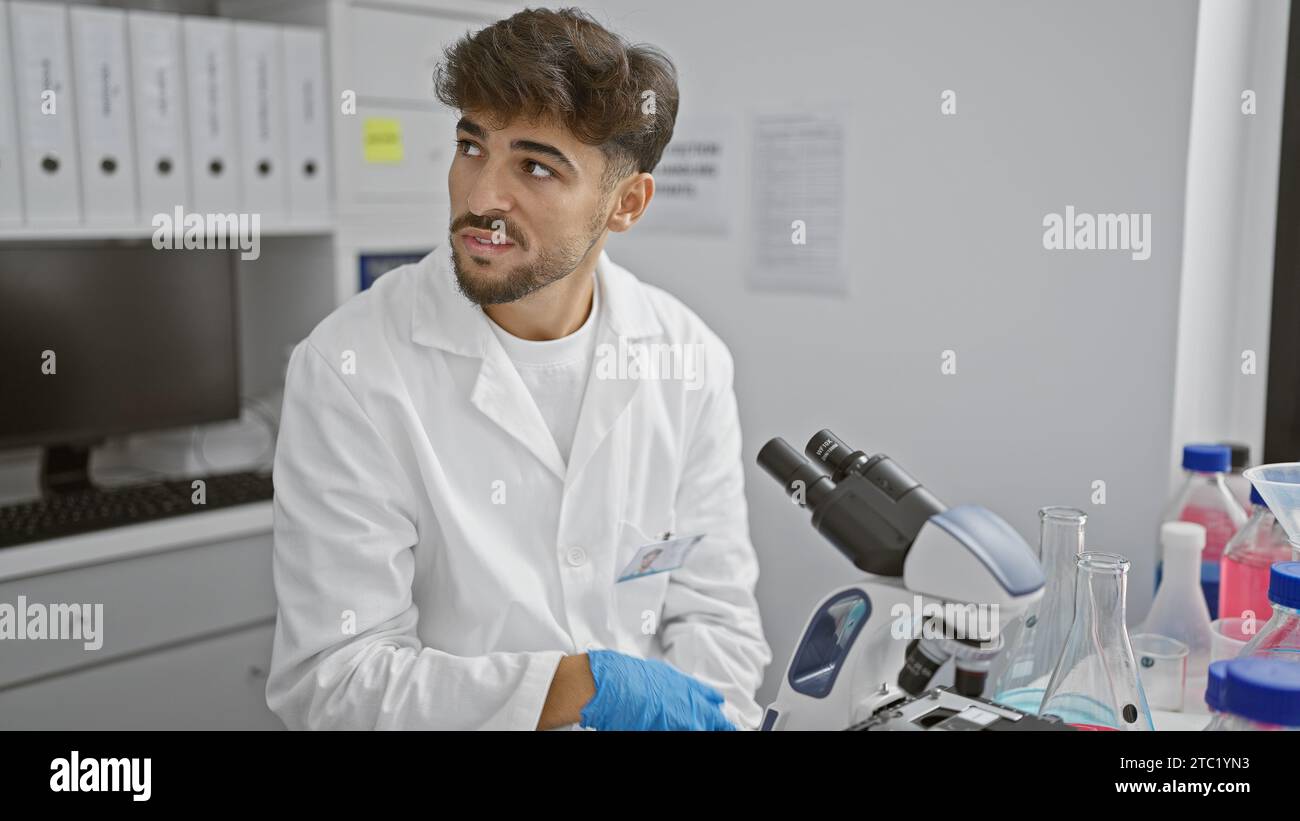 Handsome, young arabian scientist in distress, upset in laboratory over ...