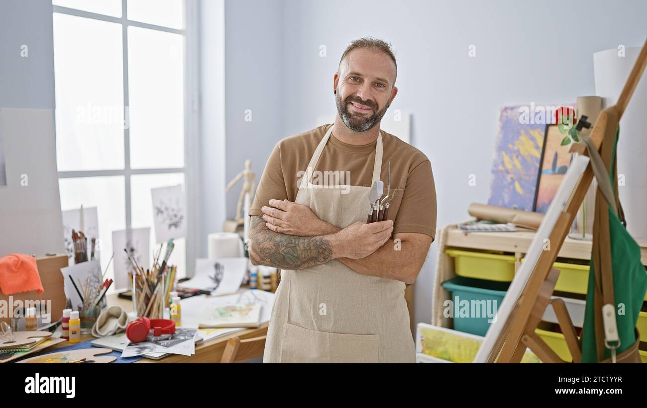Confident young man artist, bristling with creativity, standing with ...