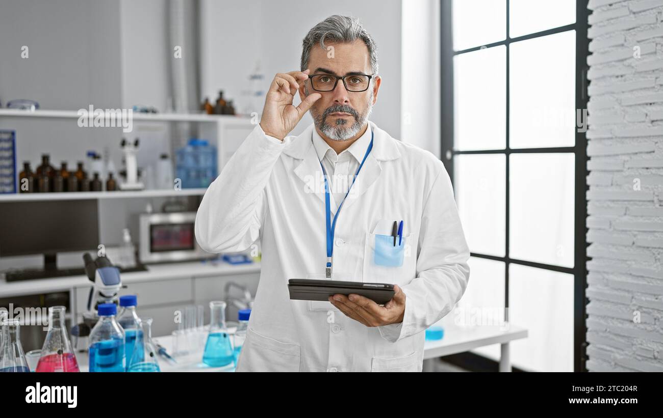 Young hispanic grey-haired man scientist using touchpad at laboratory Stock Photo - Alamy