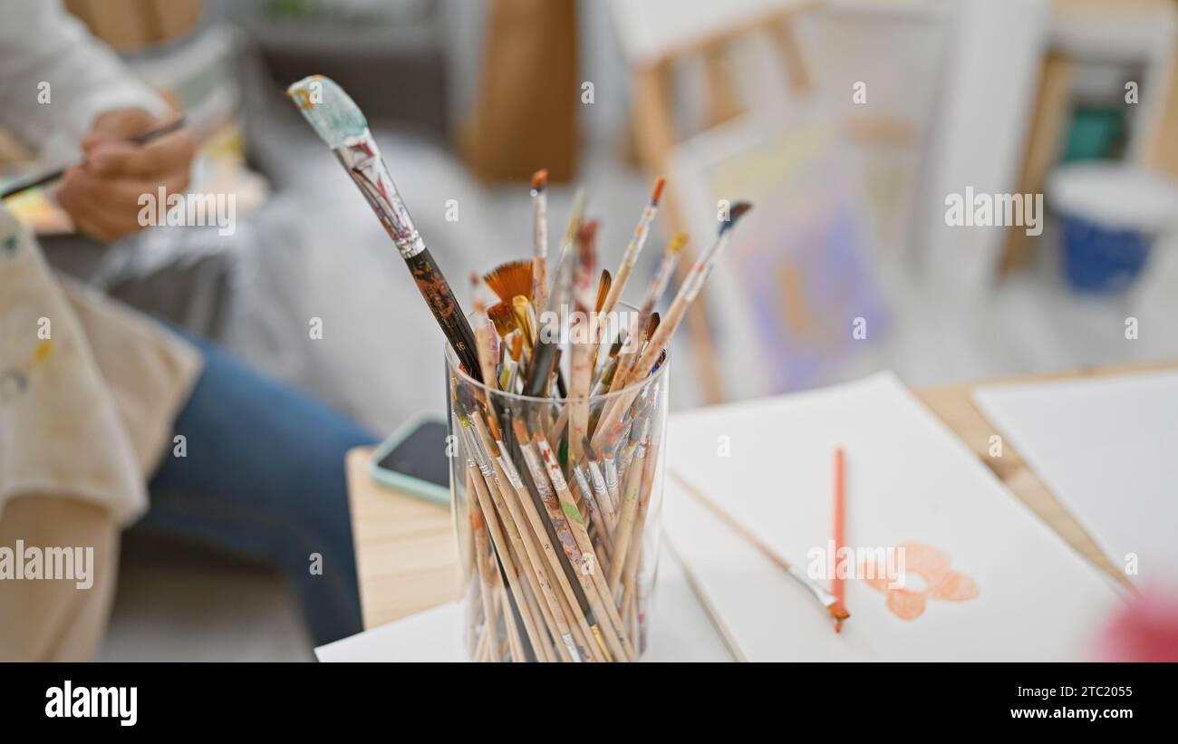 Attractive young hispanic man, grey-haired artist expressing creativity ...