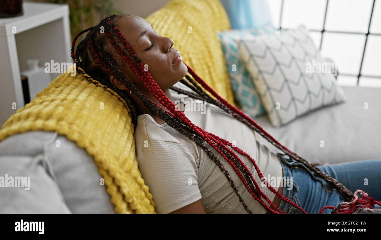 Exhausted african american woman finds comfort sleeping on her cozy ...