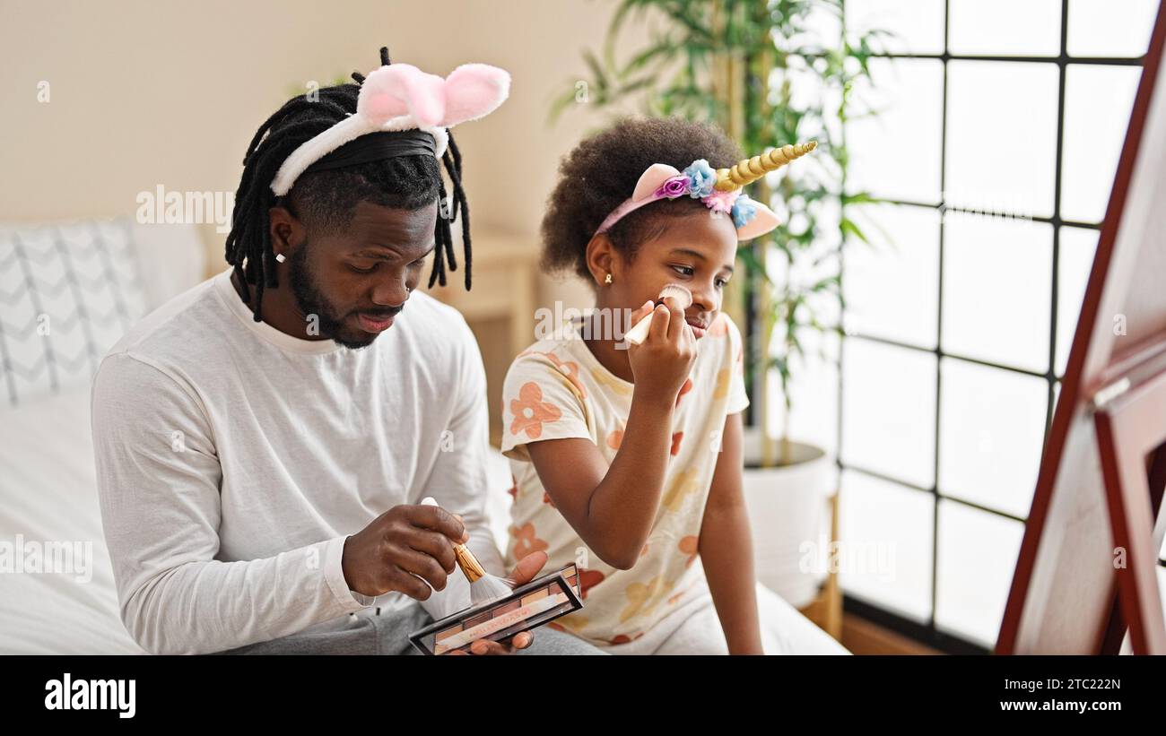 African american father and daughter wearing funny diadem applying ...