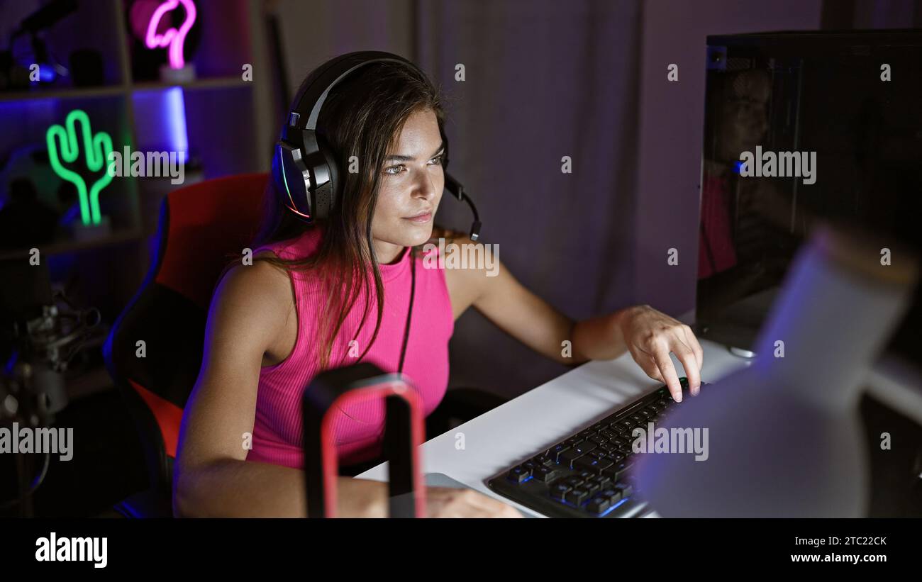 Young beautiful hispanic woman streamer playing video game using ...