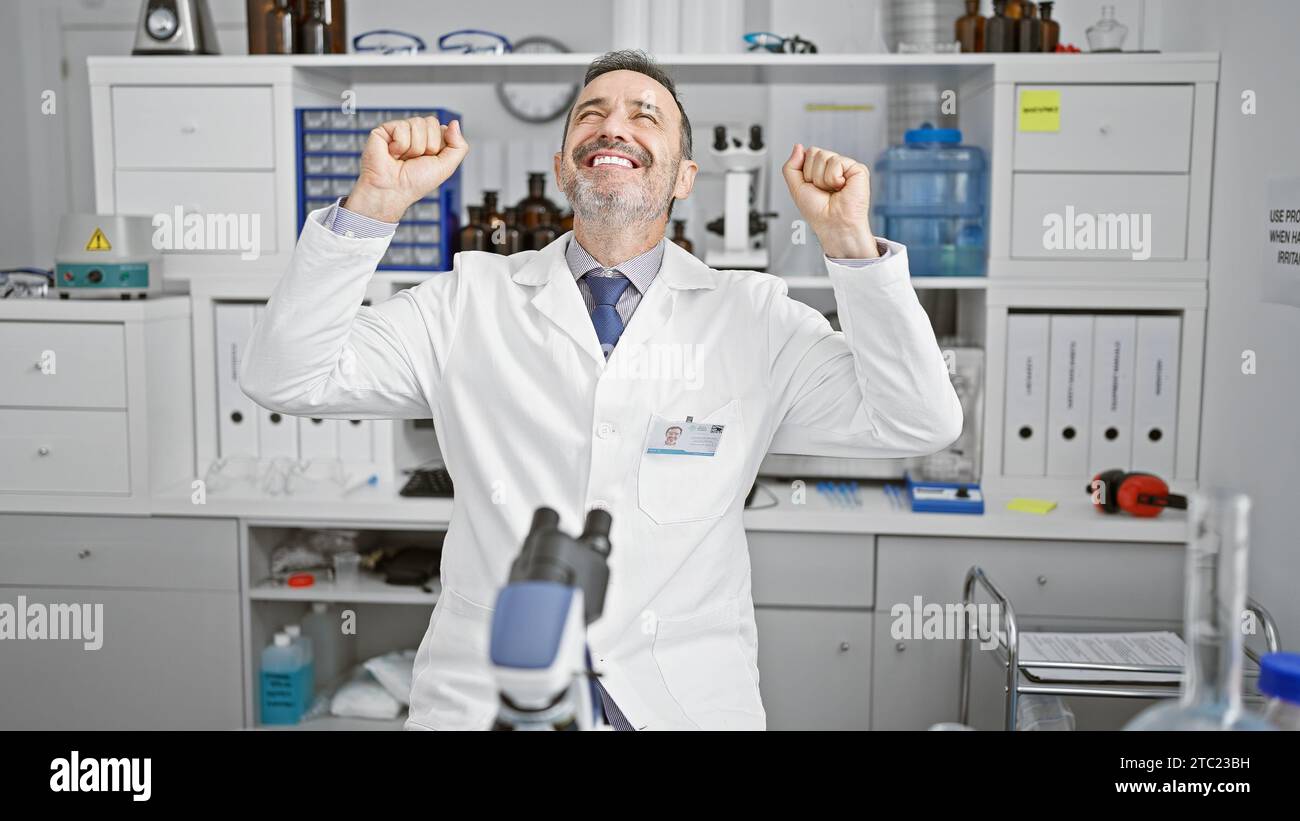Happy middle age man with grey hair, celebrating a scientific ...