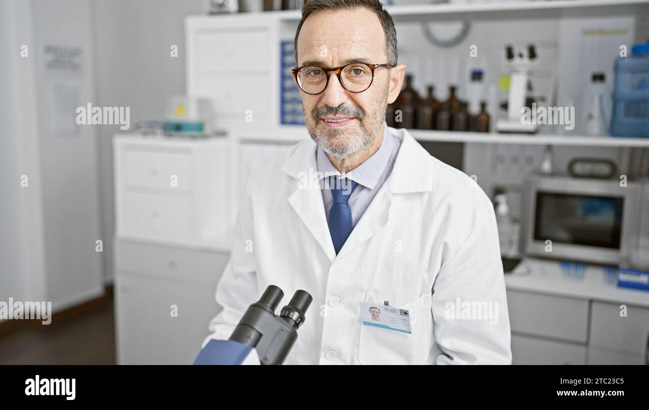 Smiling middle-age man with grey hair joyfully discovers breakthrough ...